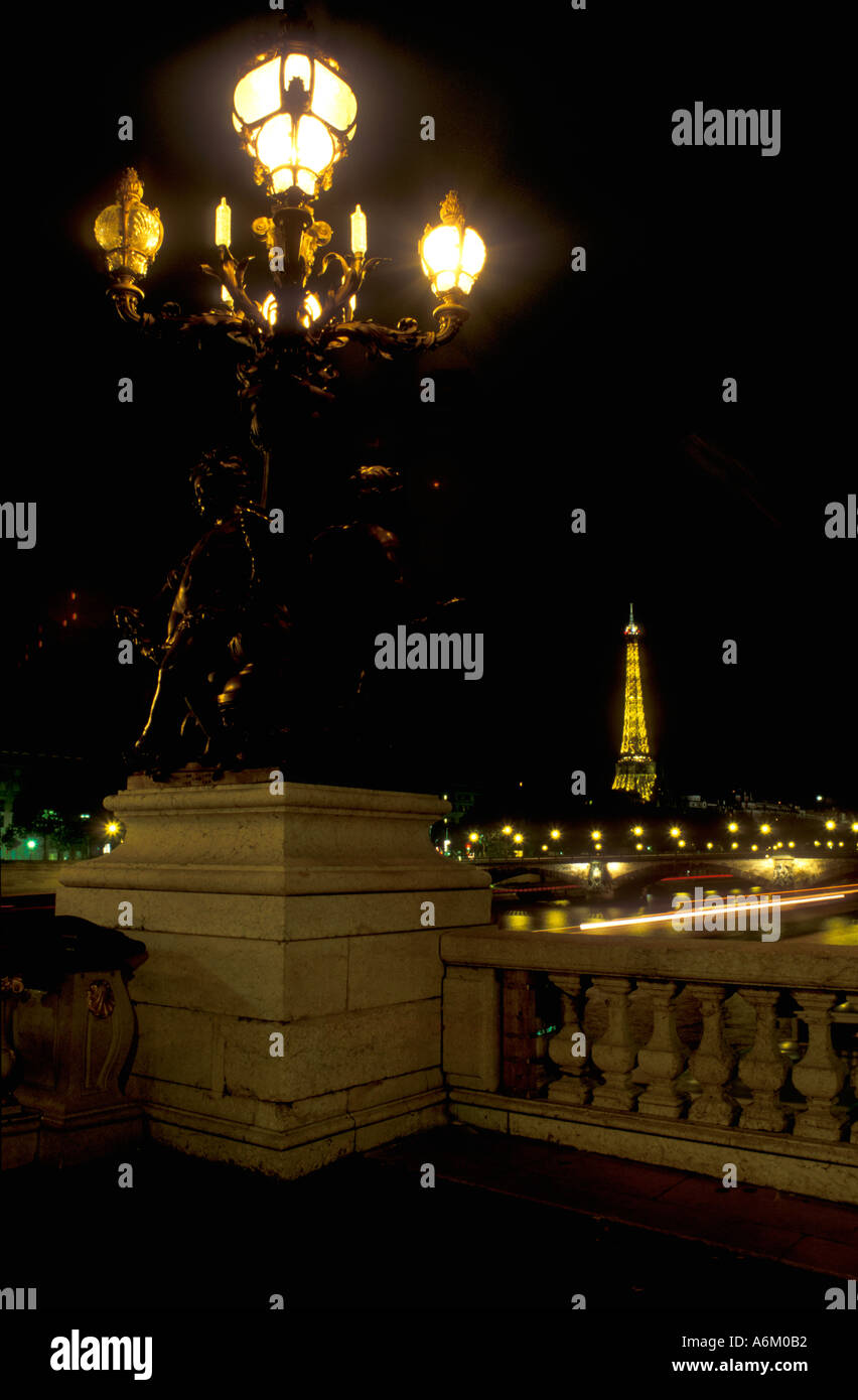 Paris Pont Alexandre III at night with river Seine and Eiffel Tower ...