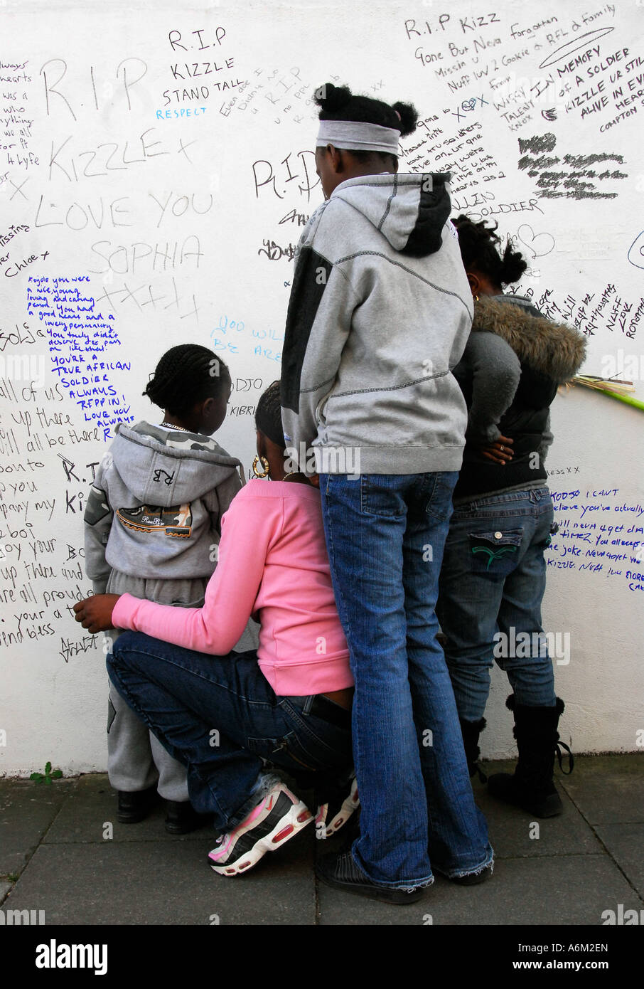 Mourners looking at written tributes to murdered teenager Kodjo Yenga ...