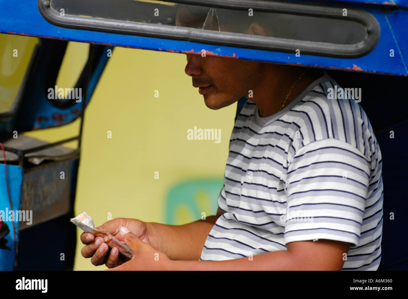 Taxi driver counting his money Stock Photo - Alamy
