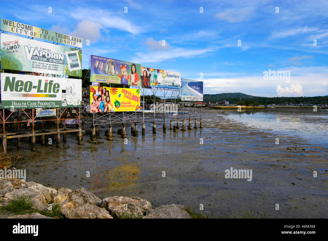 Advertisment for luxury resort on front of poor area Stock Photo - Alamy