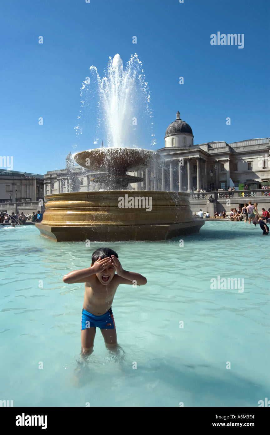Young child cooling off in fountain during heat-wave at Trafalgar ...