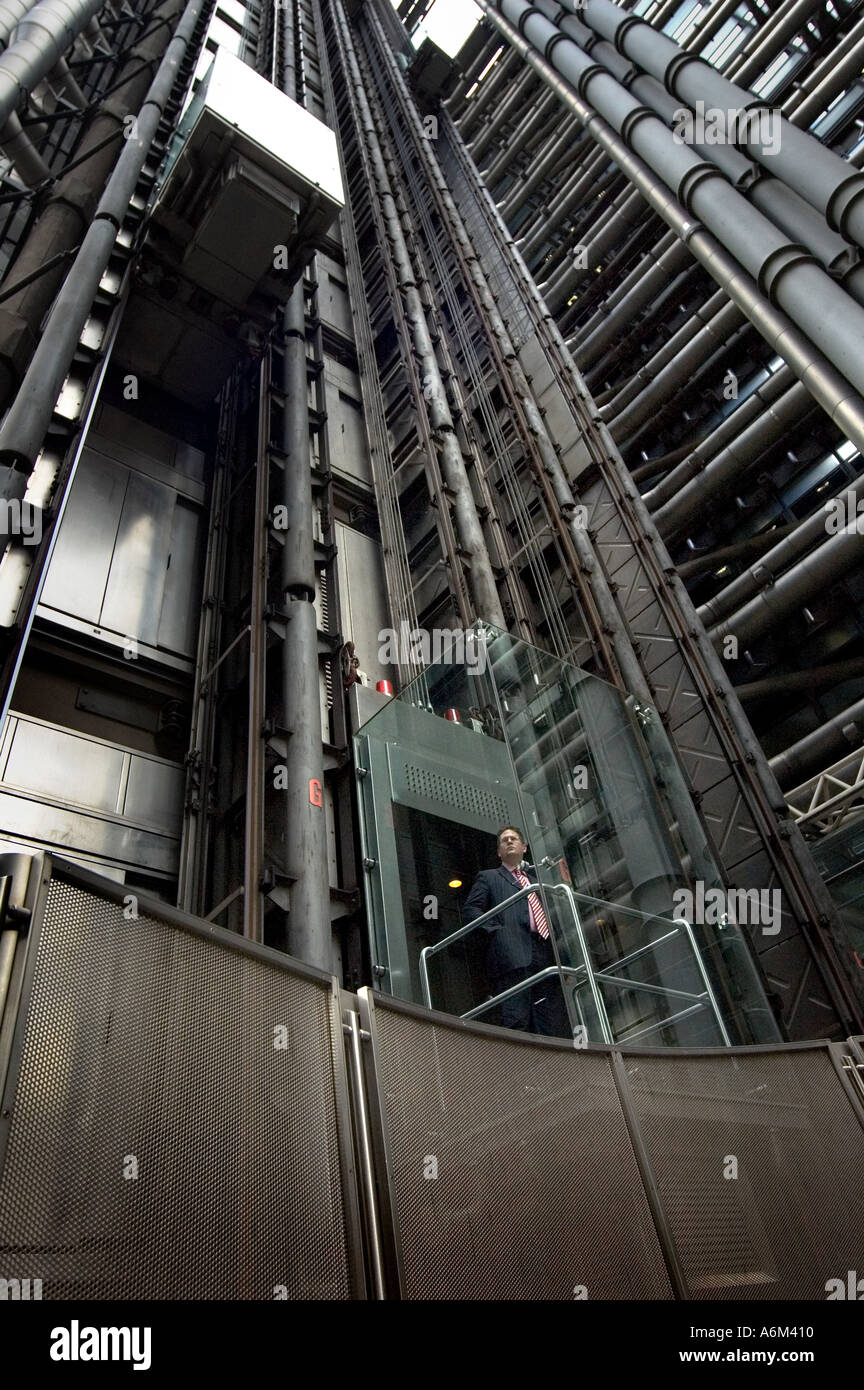 Business man in glass elevator at Lloyds of London Stock Photo - Alamy
