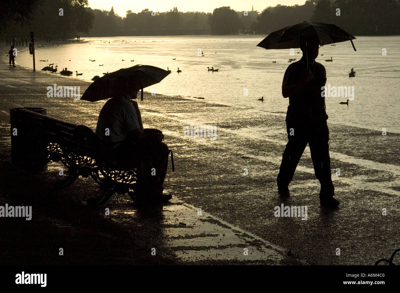 Person sheltering from rain hi-res stock photography and images - Alamy