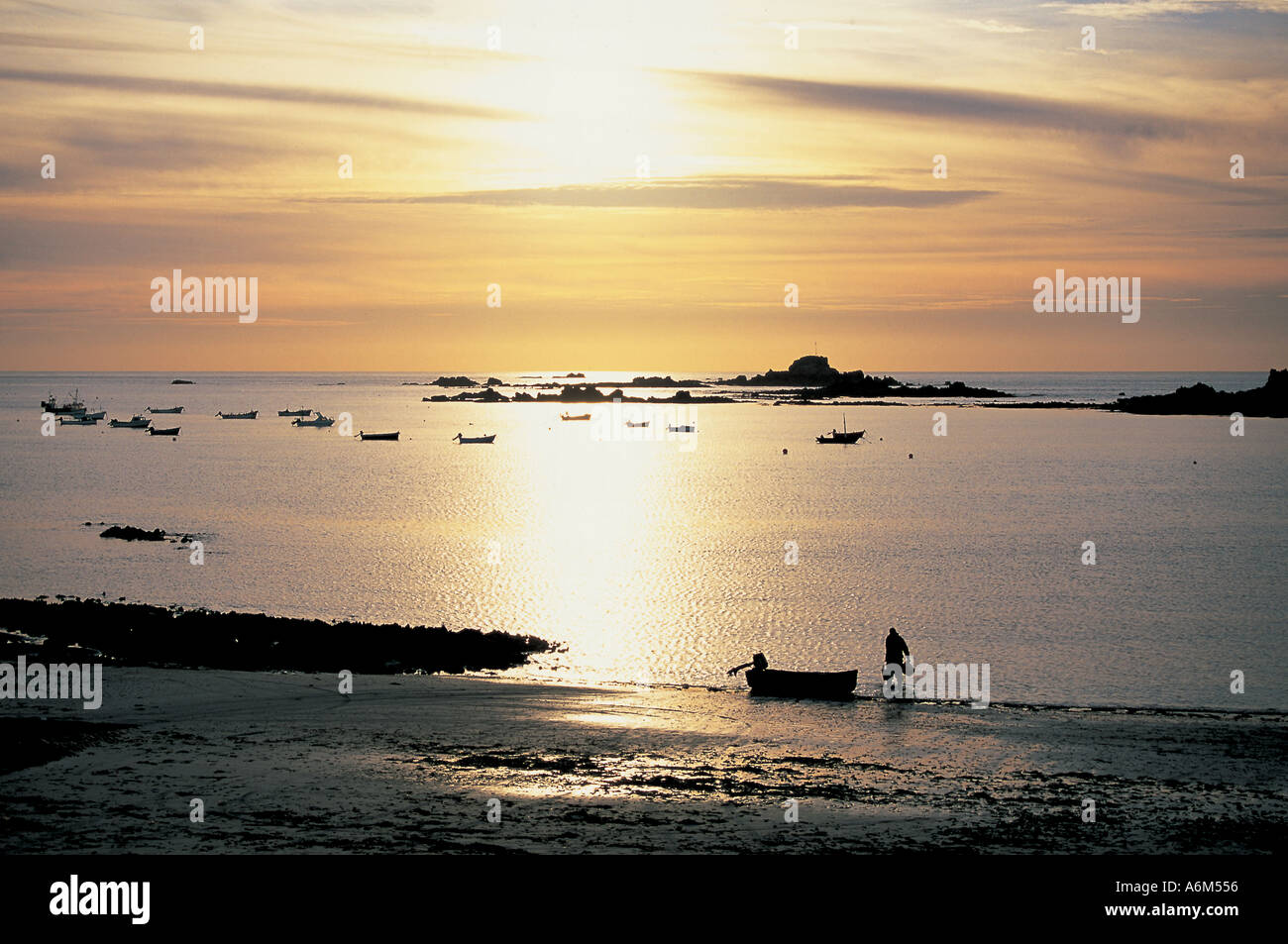 Sunset over Cobo Bay Stock Photo - Alamy