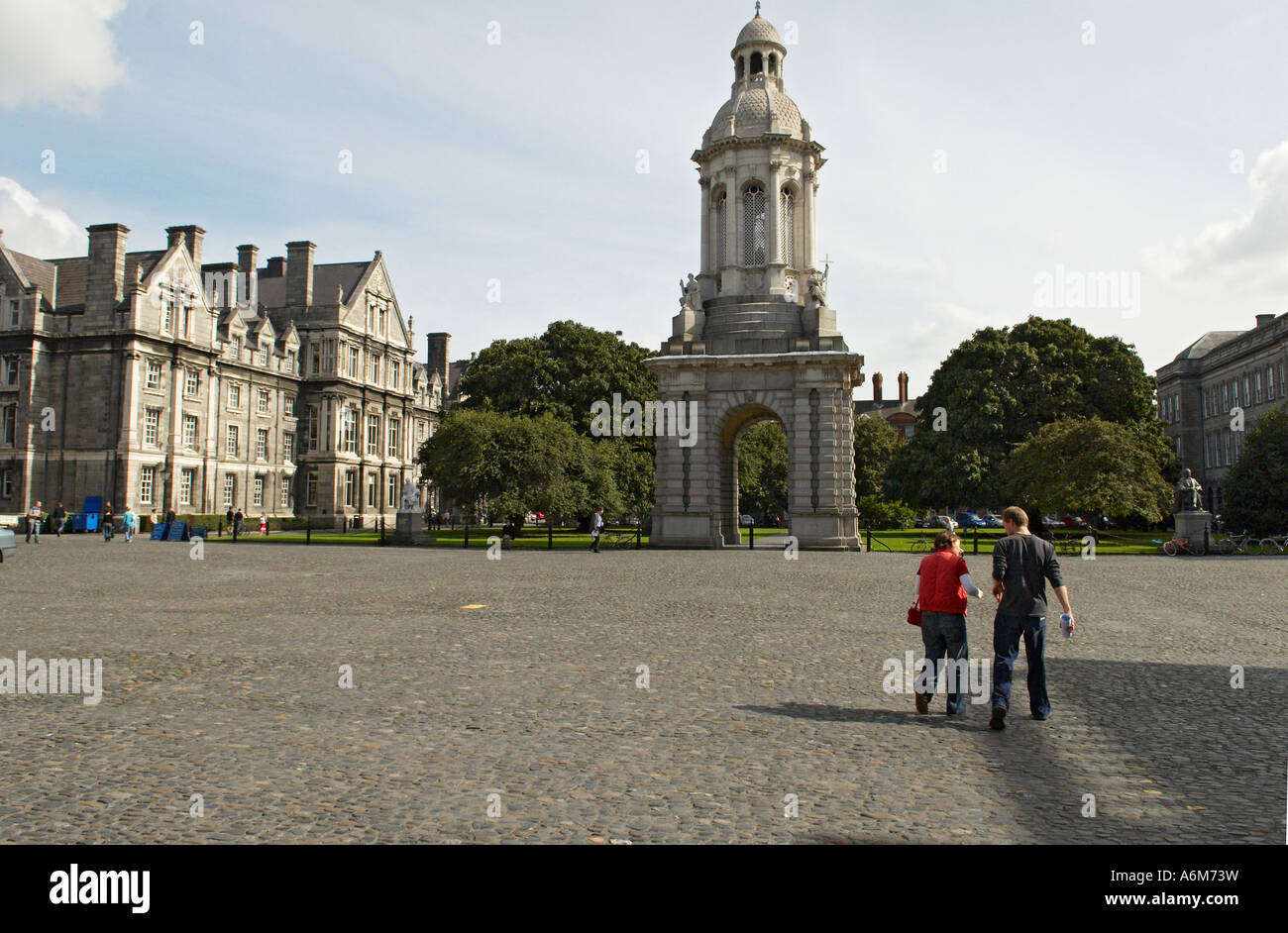 A couple walking near the tower and archway on the quadrangle at ...