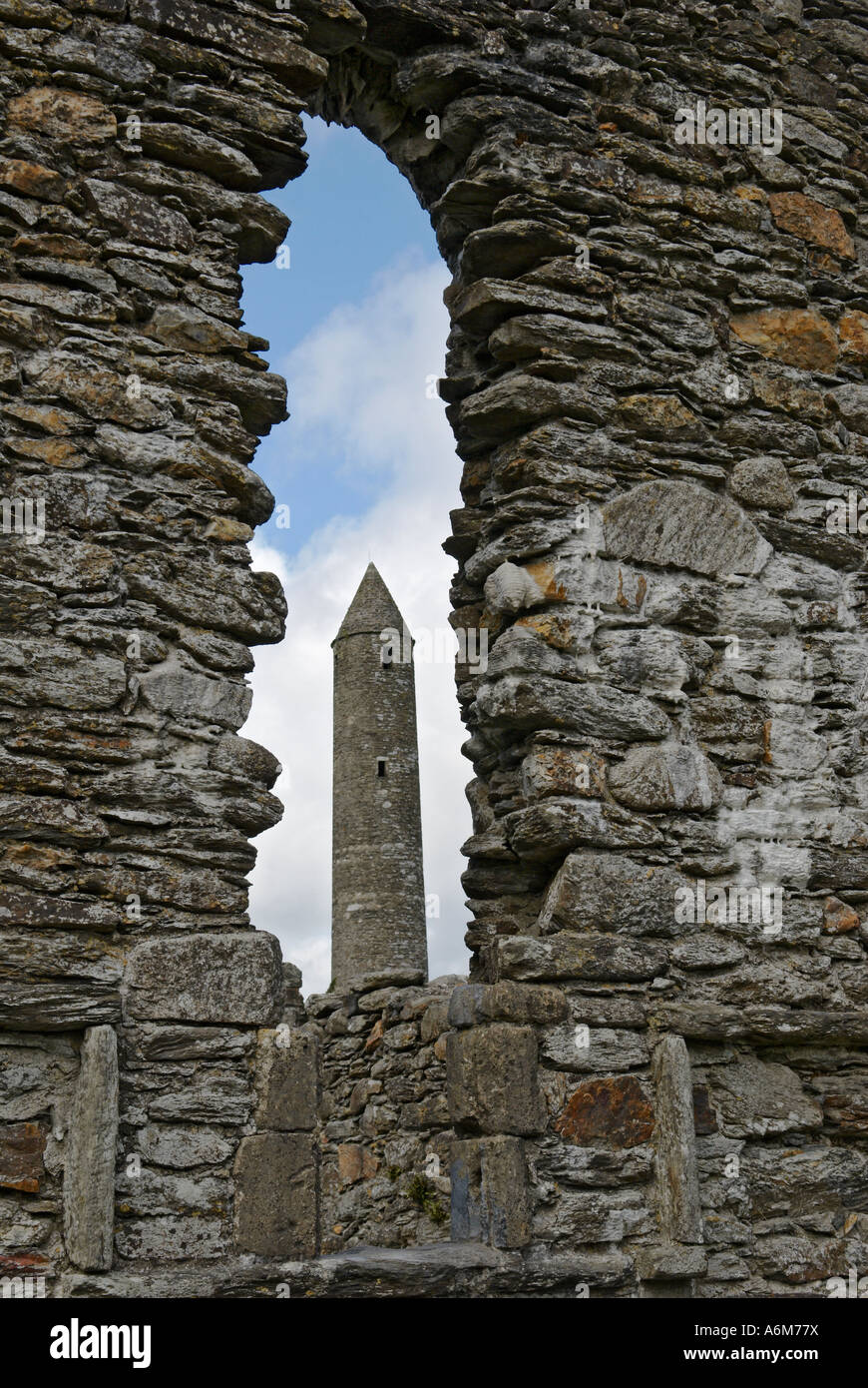 Round Tower as seen through an arched opening in a stone wall at ...