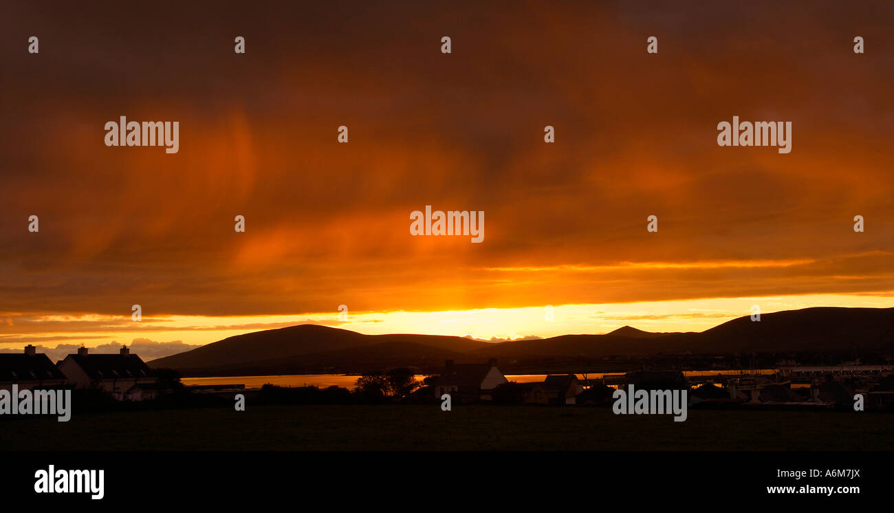 A blazing sunset panorama from the town of Dingle on the Dingle ...