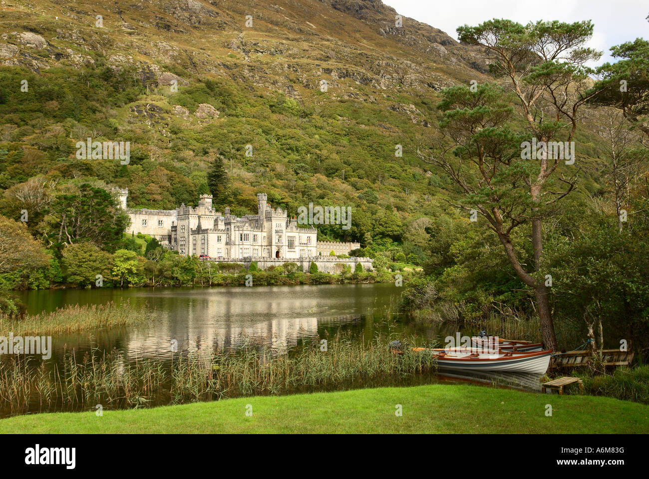 Exterior view of the imposing Kylemore Abbey and its reflection along ...