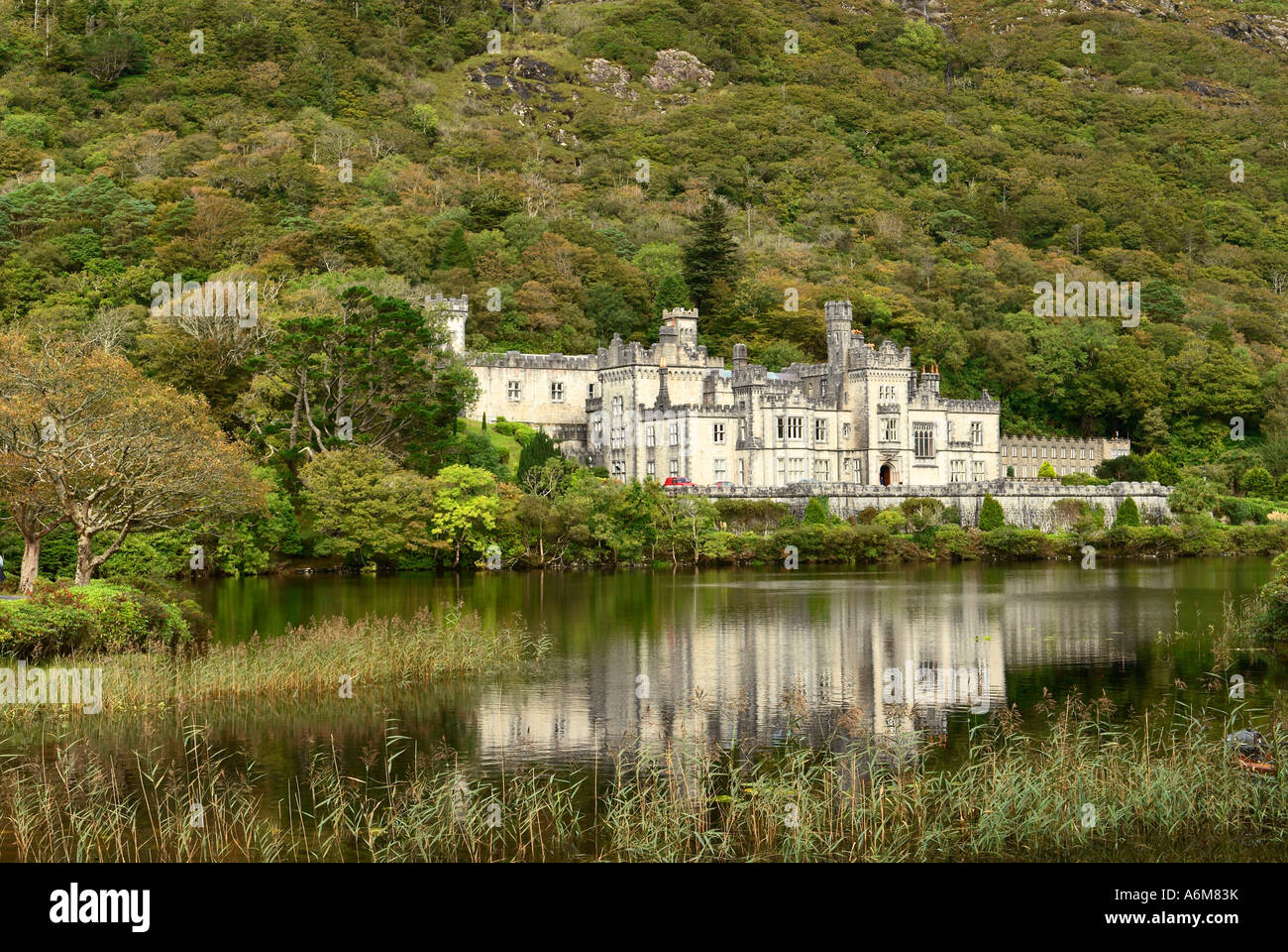 Exterior view of the imposing Kylemore Abbey and its reflection along ...
