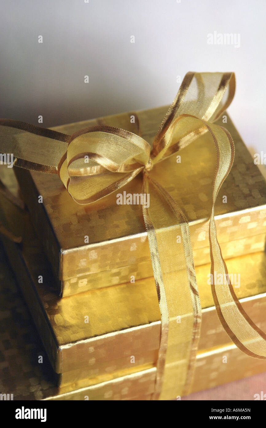 Stack of Three 3 Gold Gift Boxes Tied Together with Gold Ribbon Copy ...