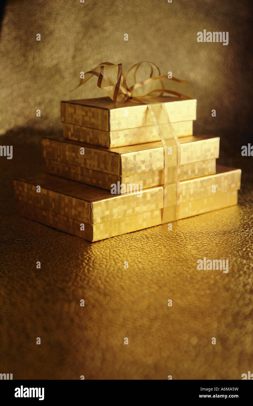 Stack of Three 3 Gold Gift Boxes Tied Together with Gold Ribbon Copy ...