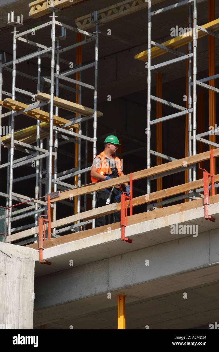 Construction worker at work surrounded by scaffolding on a new build ...