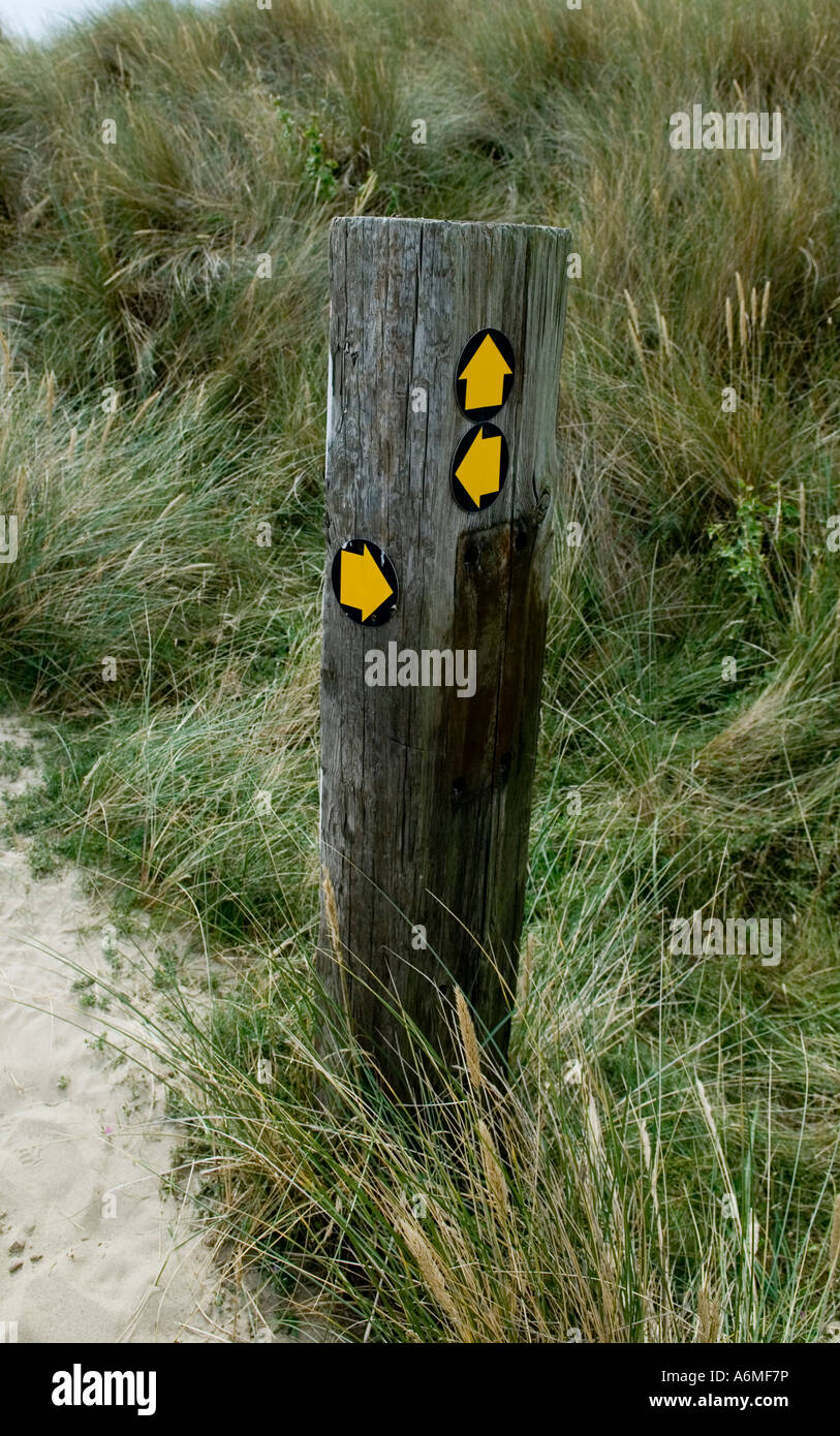 Directional arrows on wooden post Stock Photo - Alamy