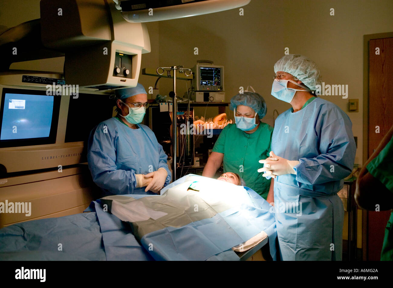 Doctors and nurses gather around operating table during surgery Stock ...