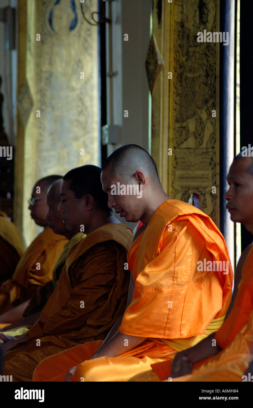 Buddhist monks holding prayers Stock Photo - Alamy