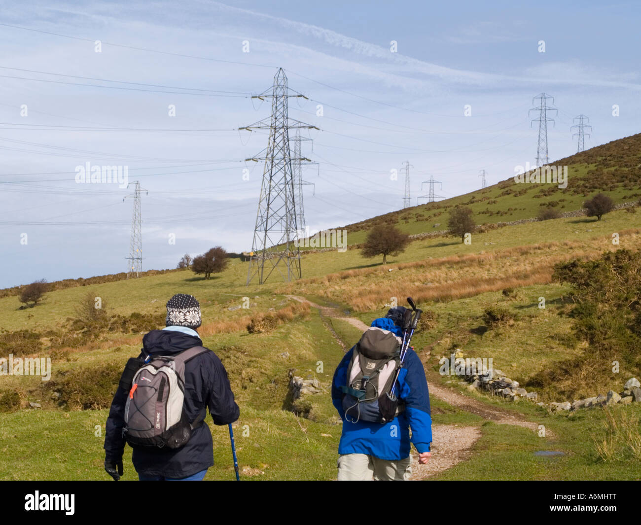 Ugly electricity pylons across North Wales Path with walkers in ...