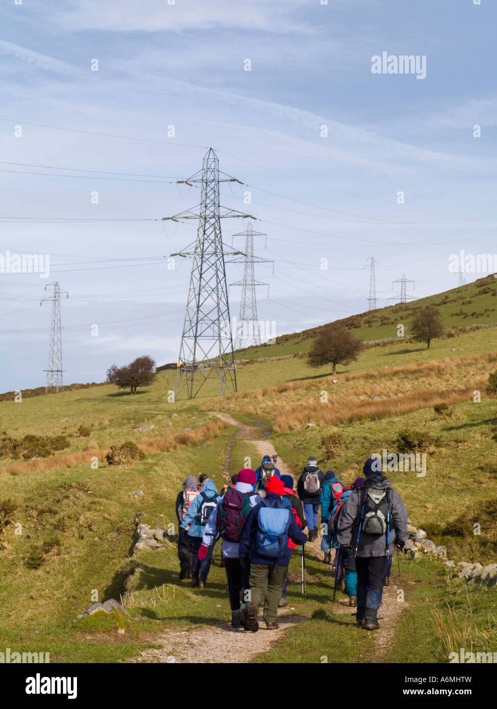 Ugly electricity pylons across North Wales Path with walkers in ...