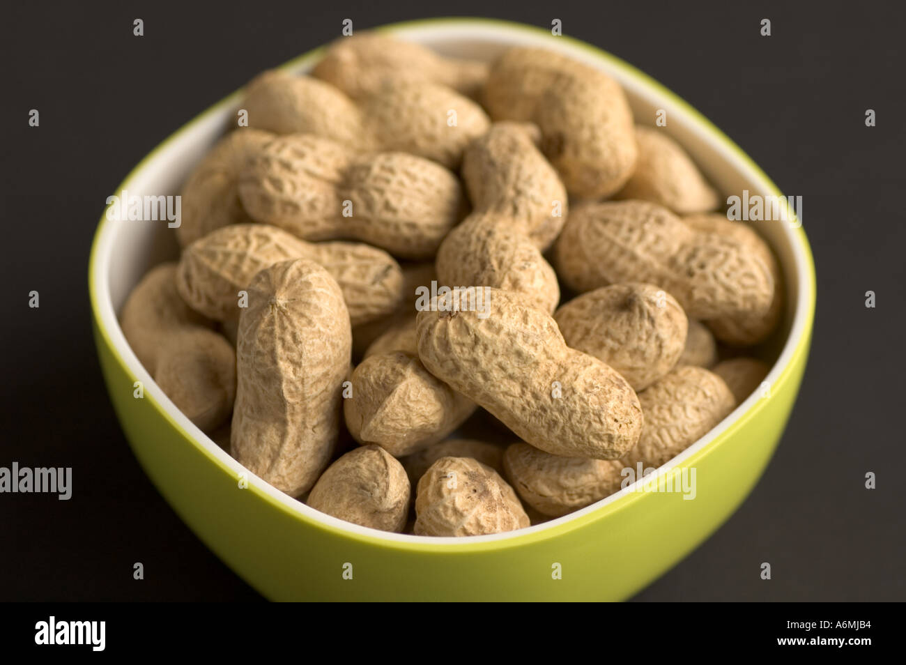 Peanuts monkey nuts in a bowl Stock Photo - Alamy