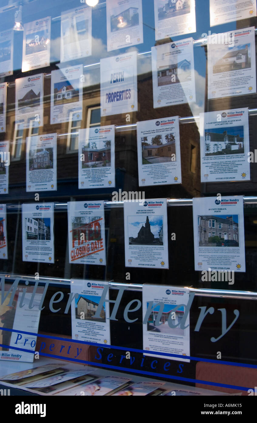 Estate agents window with sale signs Stock Photo - Alamy