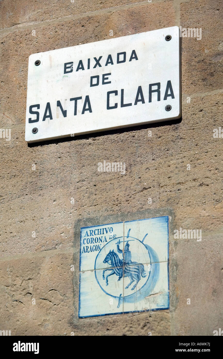 Old street sign on wall with words Baixada de Santa Clara El Barri ...