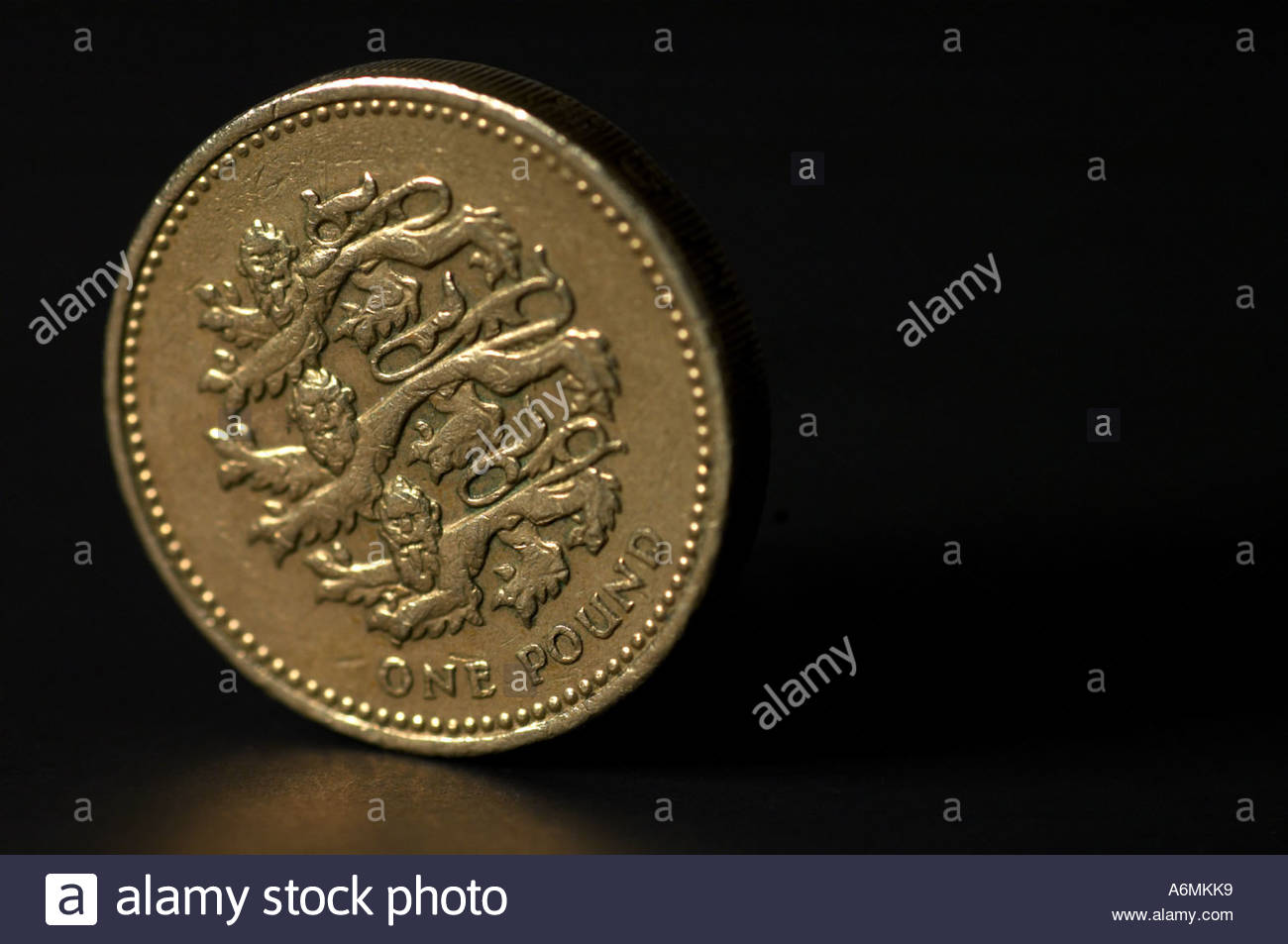 Old UK One pound coin on a black background Stock Photo - Alamy