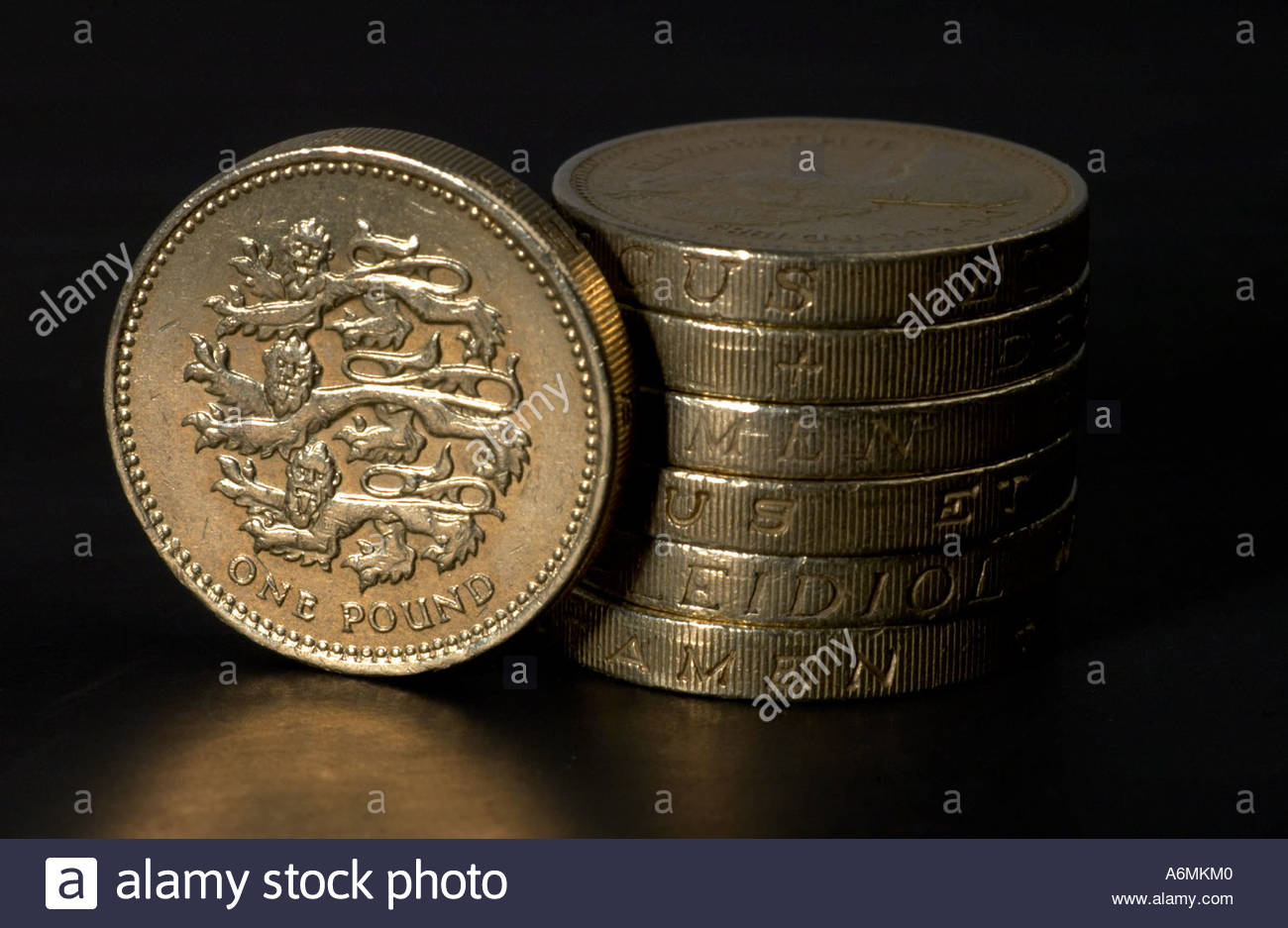 Old UK Pound coins on a black background Stock Photo - Alamy