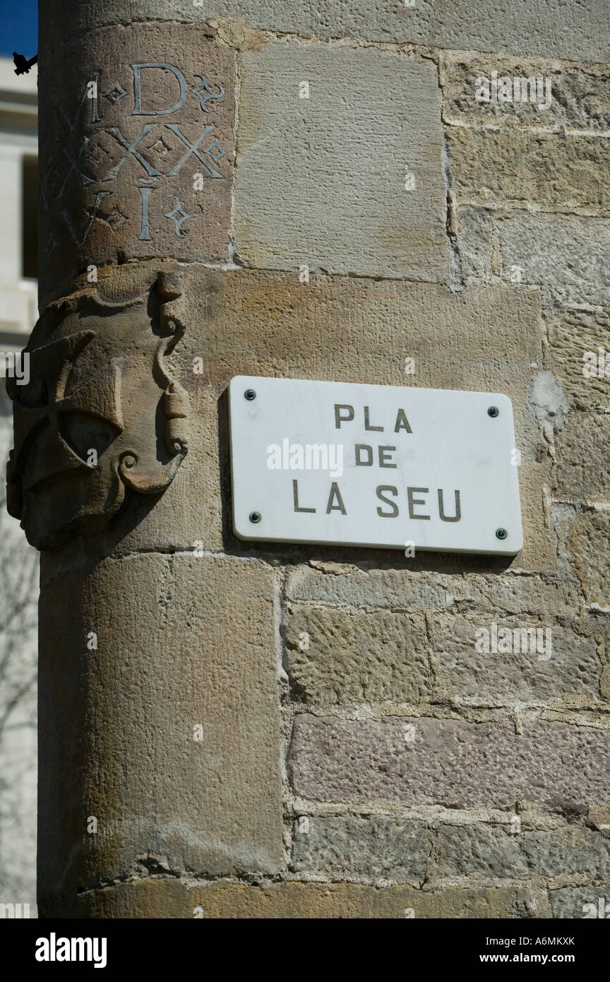 Pla de la Seu street sign in sun with Roman lettering above El Barri ...