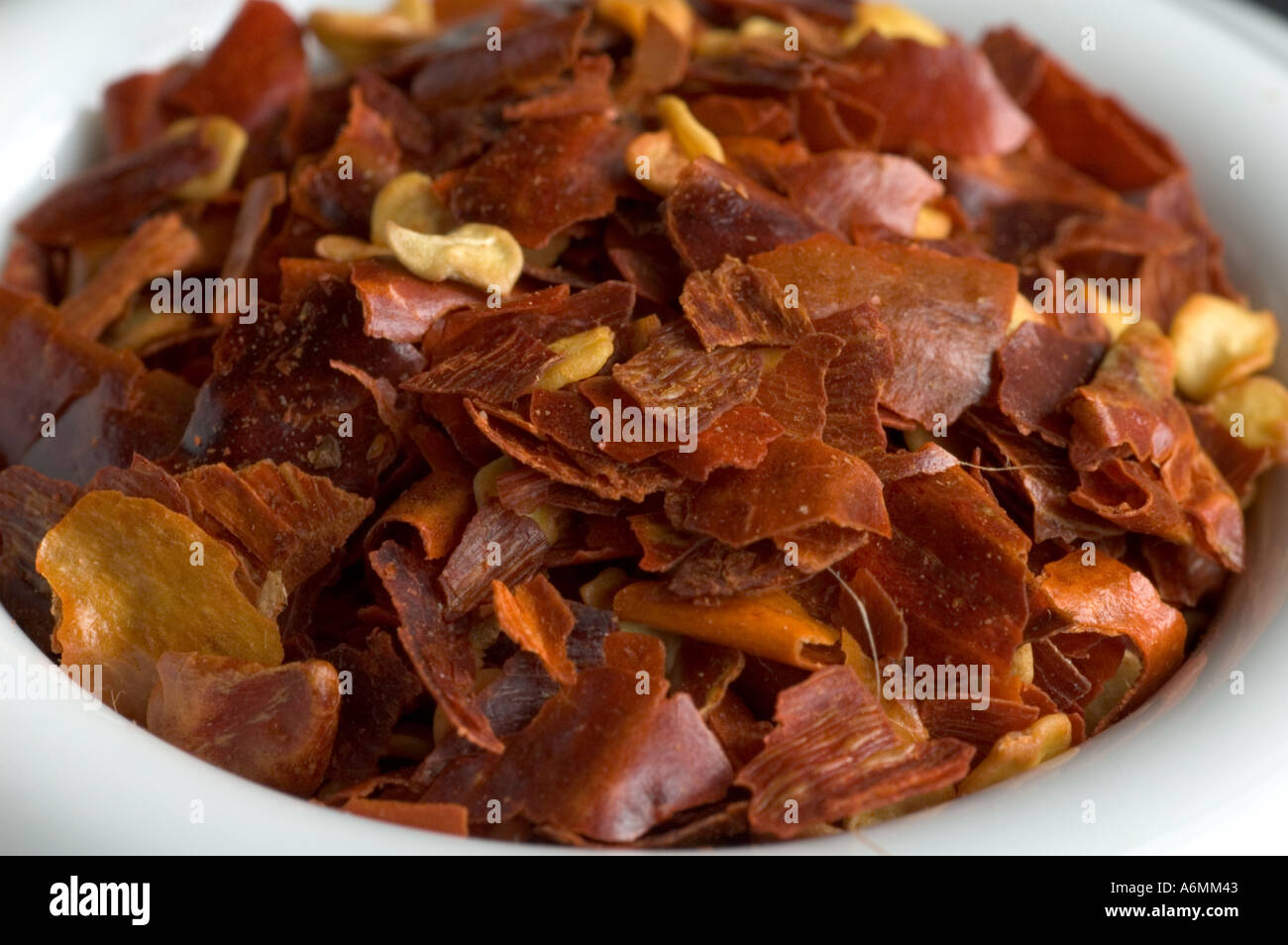 Crushed dried chilli flakes in a bowl Stock Photo - Alamy