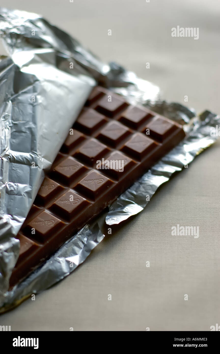 Milk chocolate bar in wrapper Stock Photo - Alamy