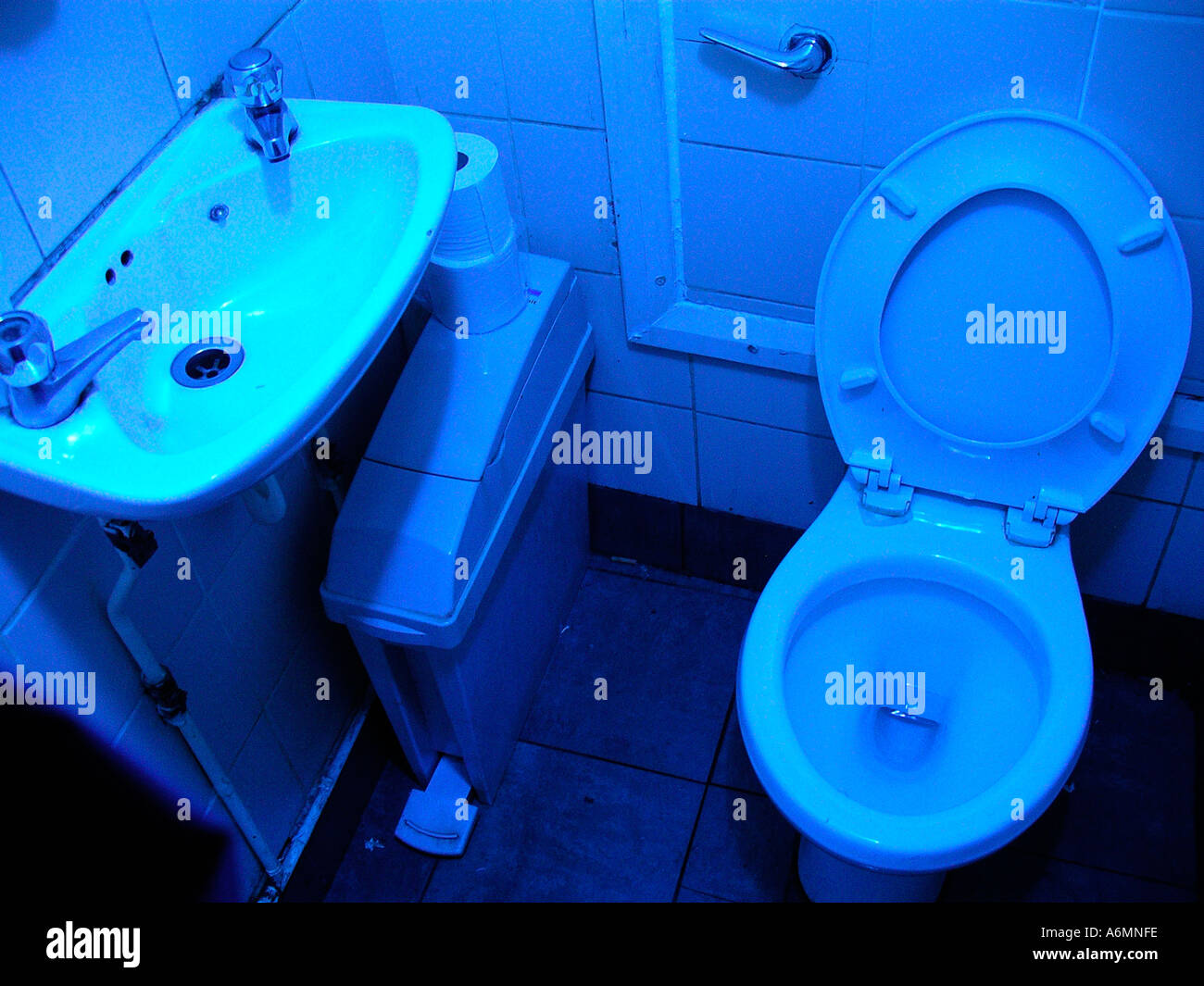 Soho toilet in ultraviolet light Stock Photo - Alamy