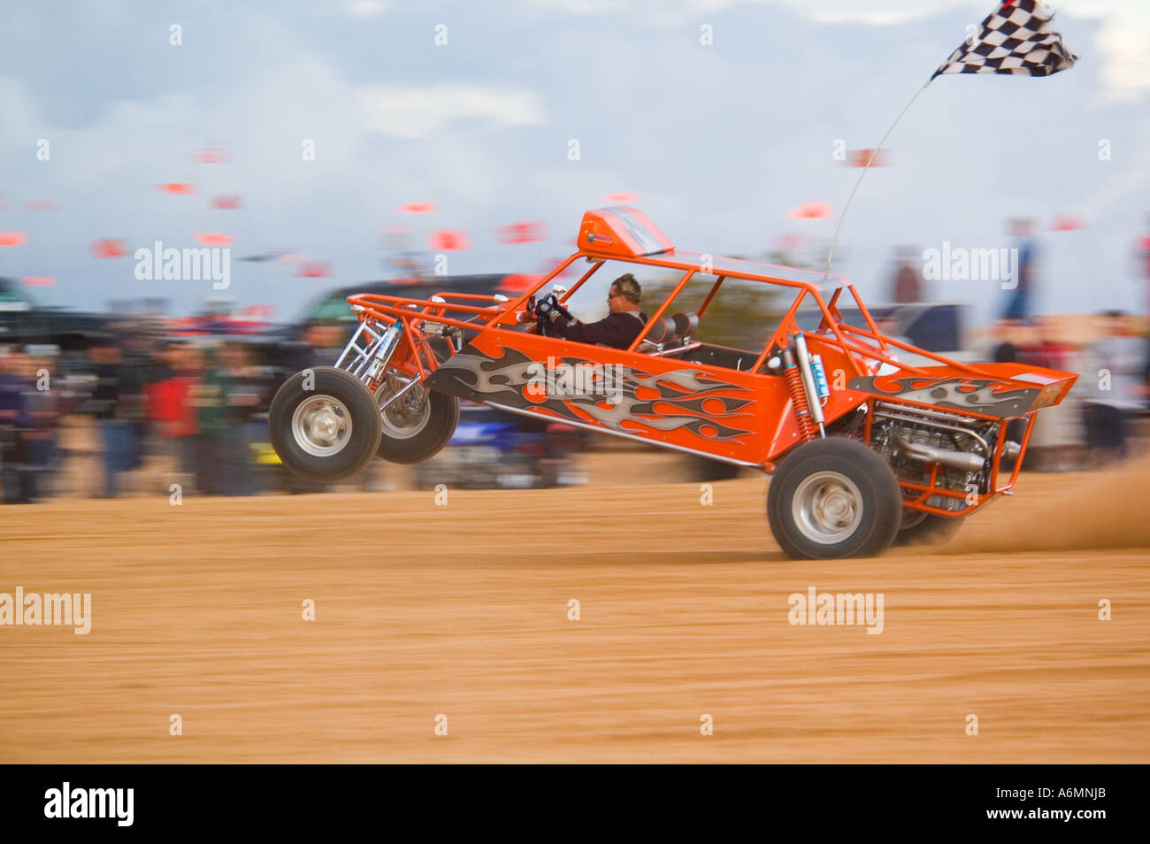 orange sand car racing while on the back wheels in the sand dunes Stock ...
