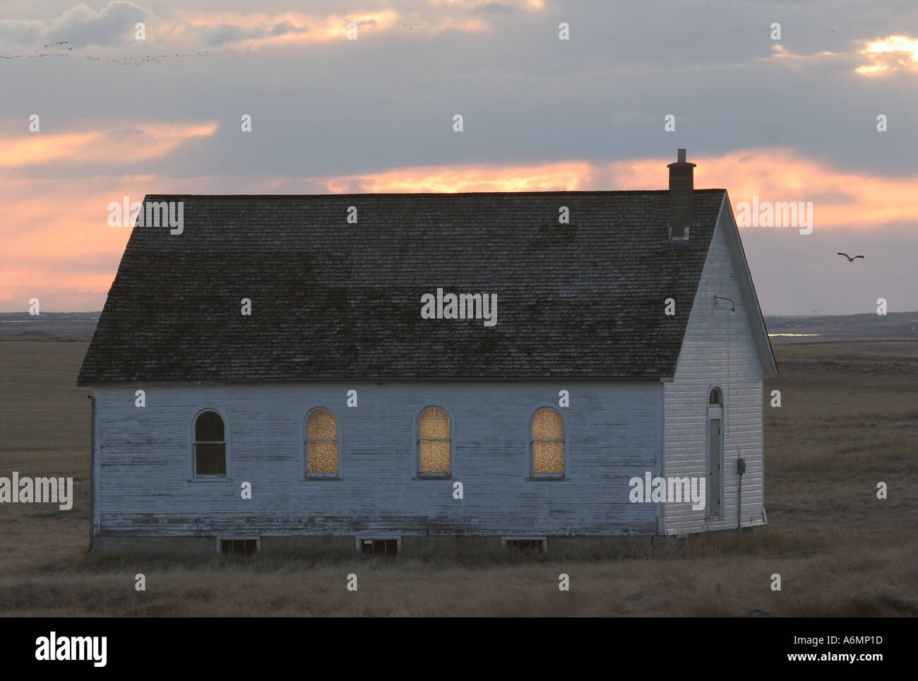 Old meeting hall with hawk in background in scenic Saskatchewan Canada ...