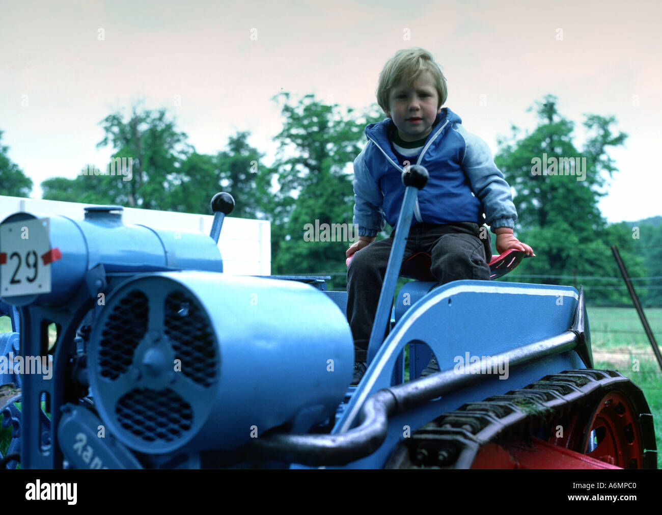 Small boy on tractor Stock Photo - Alamy