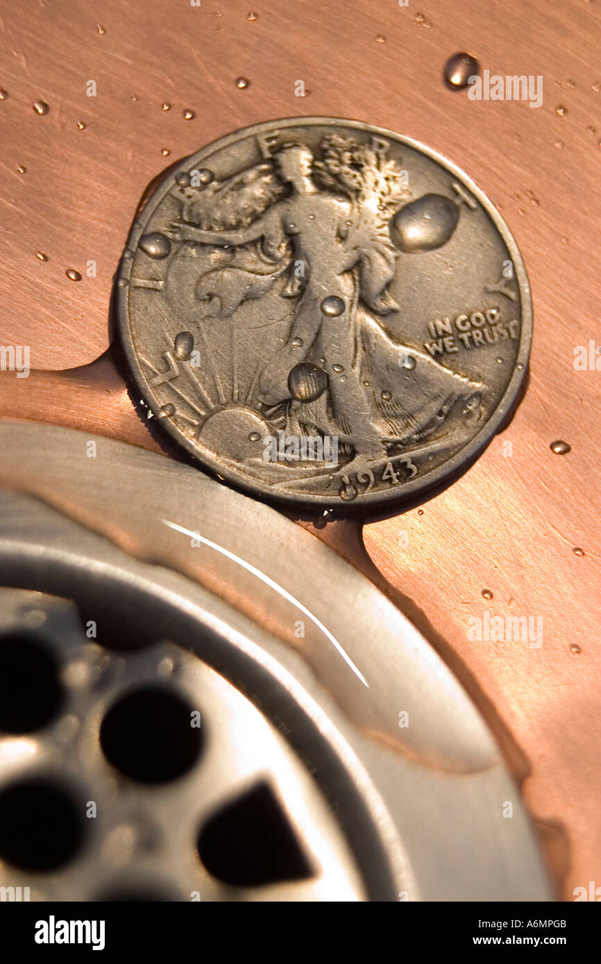 Very close shot of a Liberty U S half dollar coin laying in a wet ...