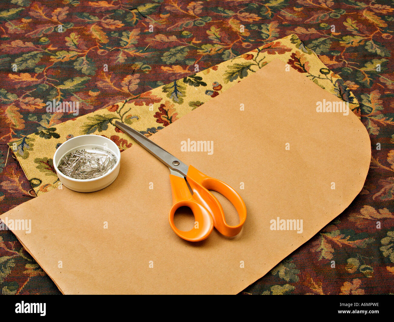 Making a pattern template out of brown paper Stock Photo - Alamy