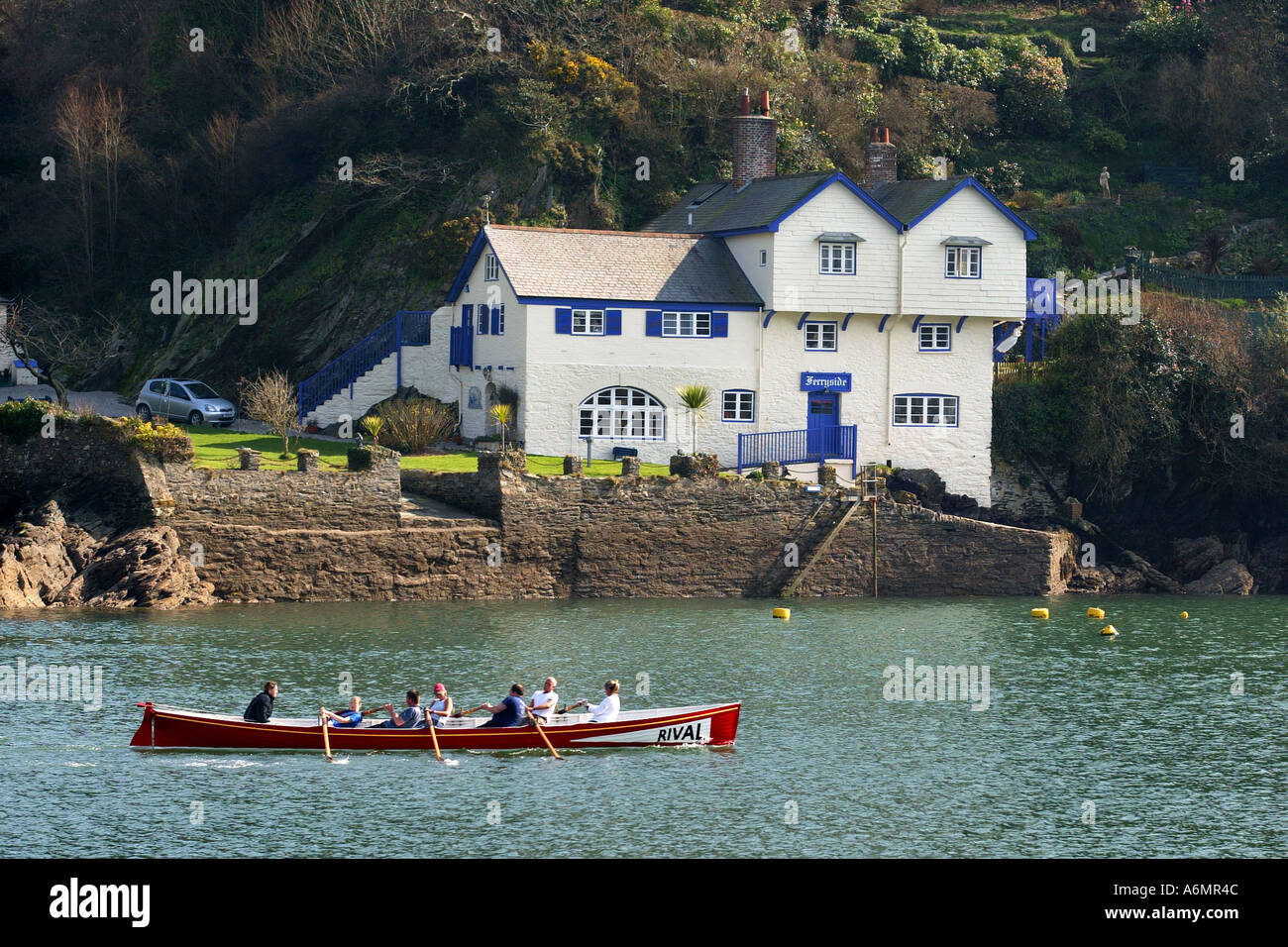 A gig is rowed past Ferryside at Bodinnick, Cornwall, bought by writer ...