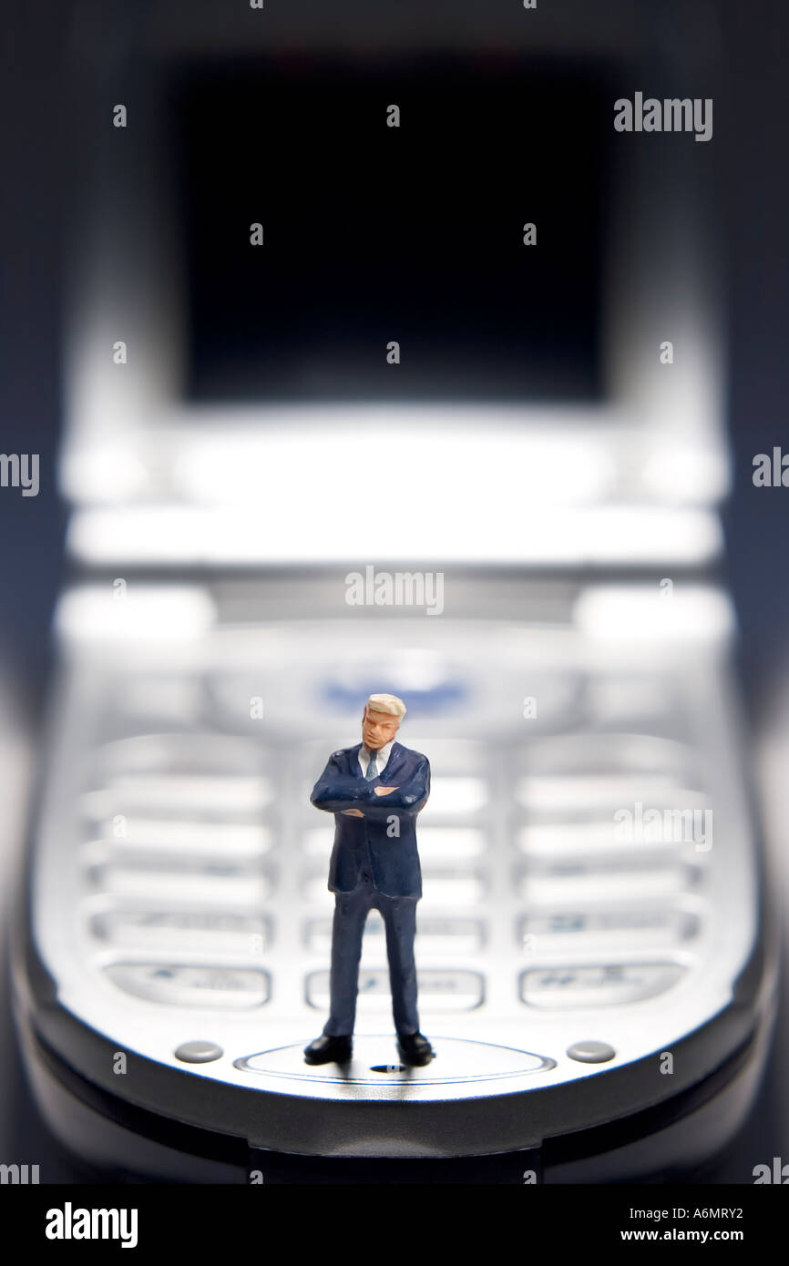 Business figure and cellular phone Stock Photo - Alamy