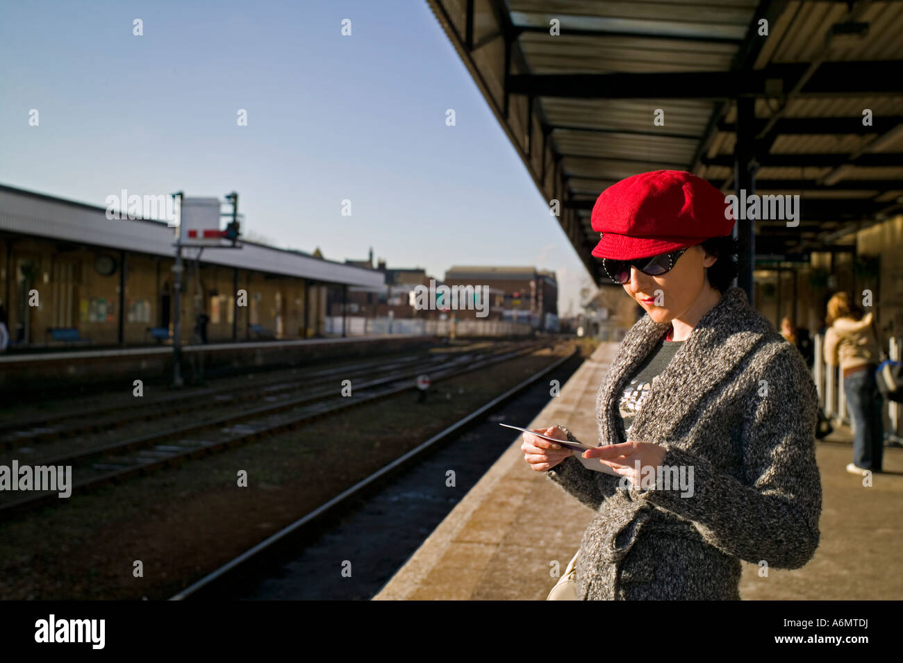 woman at a railway station Stock Photo - Alamy
