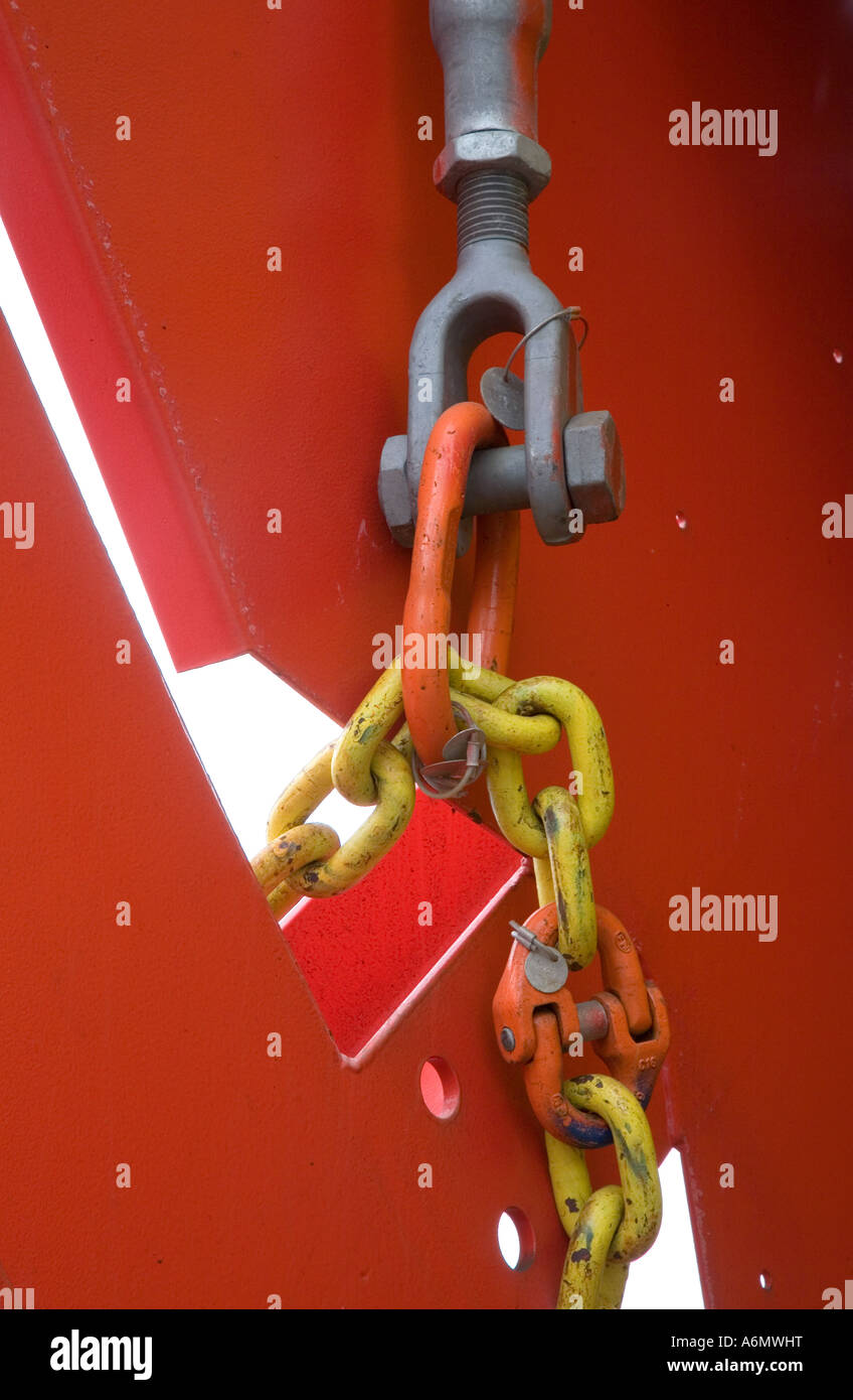 Old rig pipeline shackles and chains on giant pipe laying wheel ...