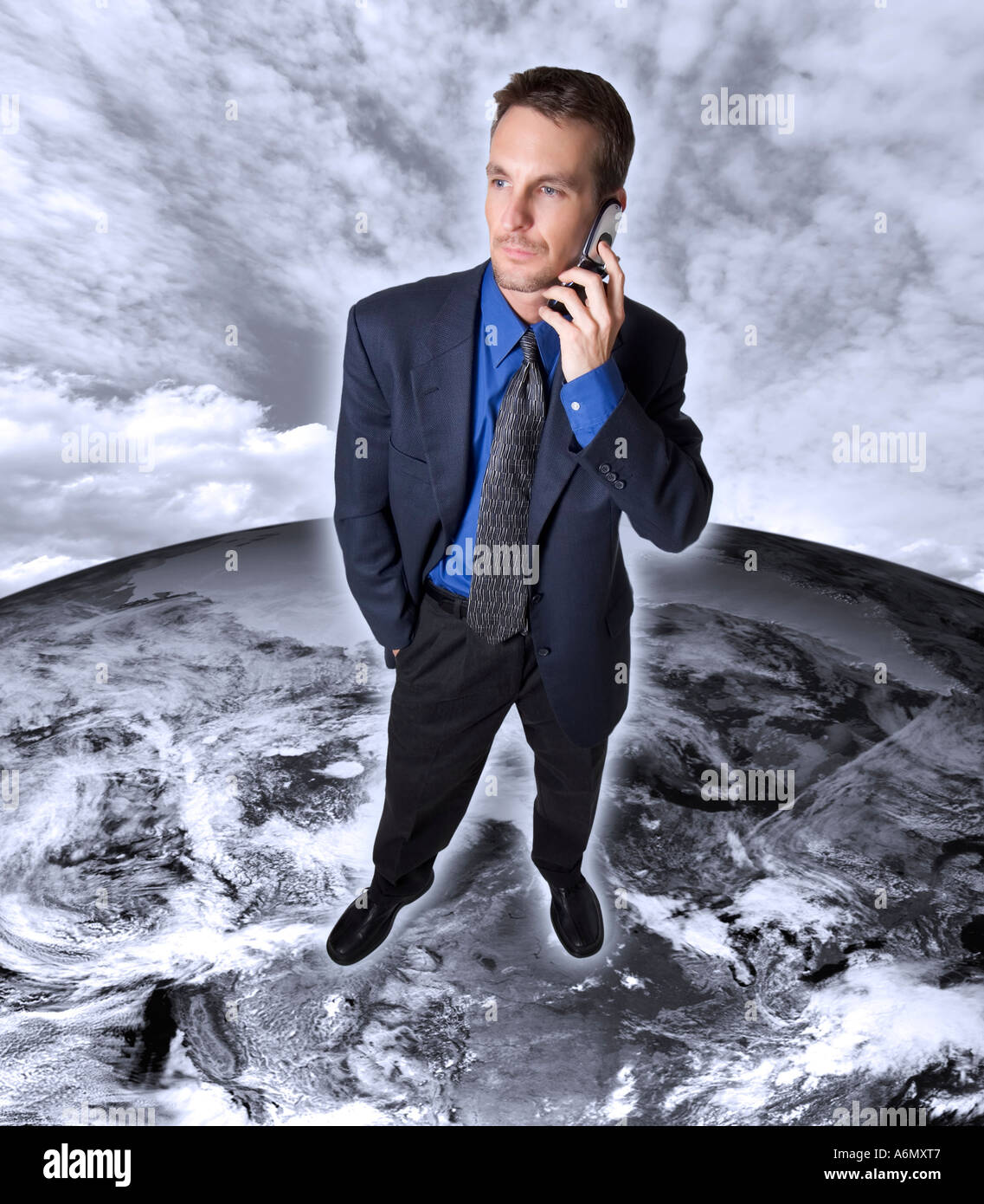 Businessman on top of earth making a cellular phone call Stock Photo ...
