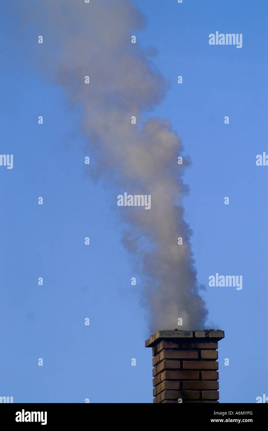 Chimney pouring plume of smoke over blue sky Stock Photo - Alamy