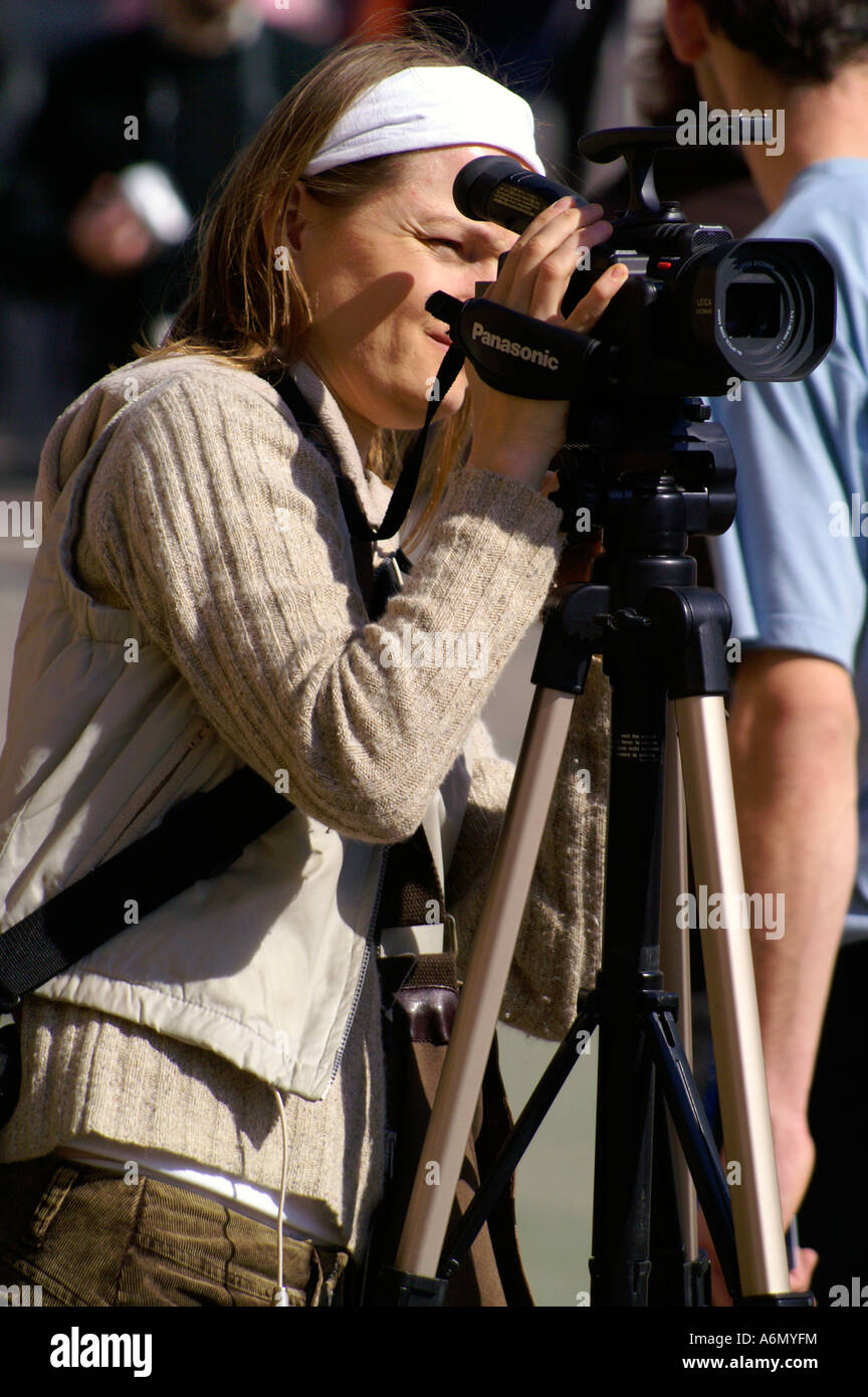 Woman girl filming with a movie camera at street in Banska Bystrica ...