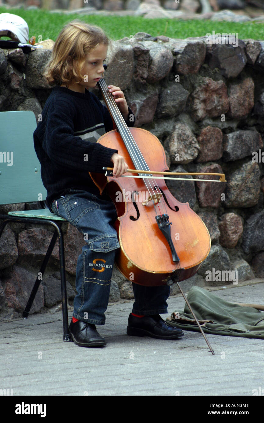 BOY PLAYING A CELLO IN RIGA OLD TOWN in Latvia Stock Photo - Alamy