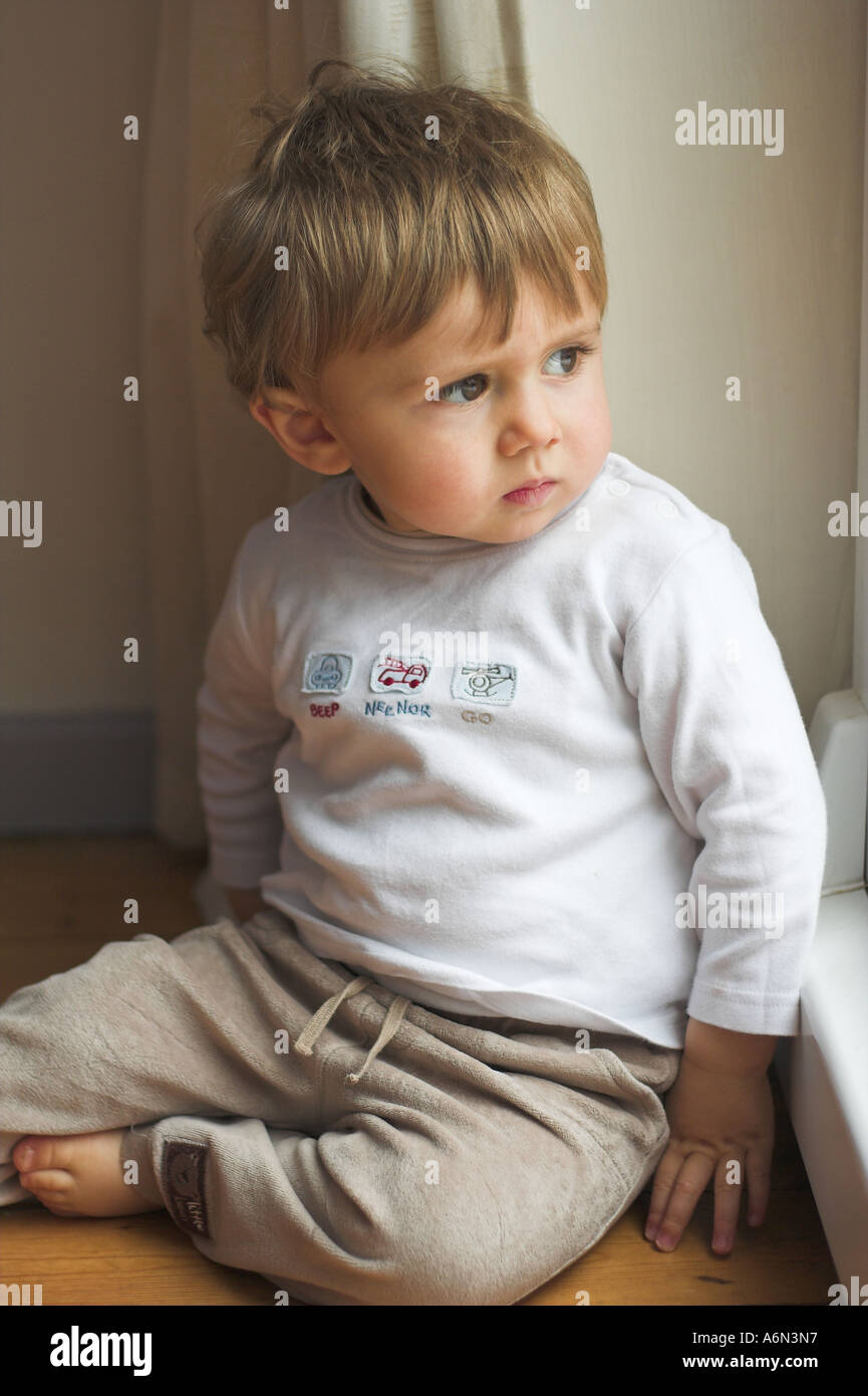 Baby boy gazing through a window Stock Photo - Alamy