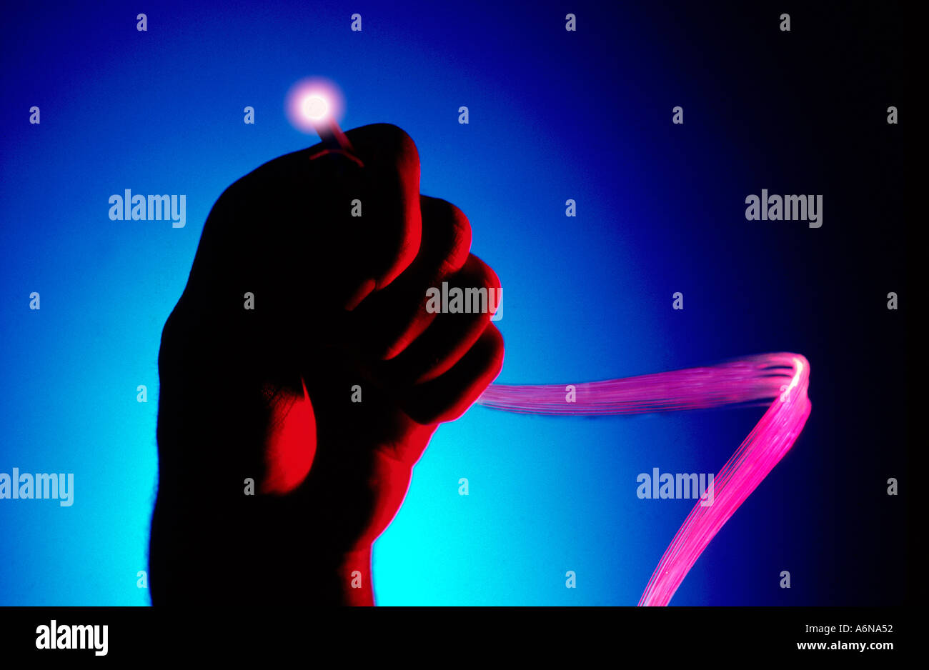 Hand holding fiber optics strand Stock Photo - Alamy