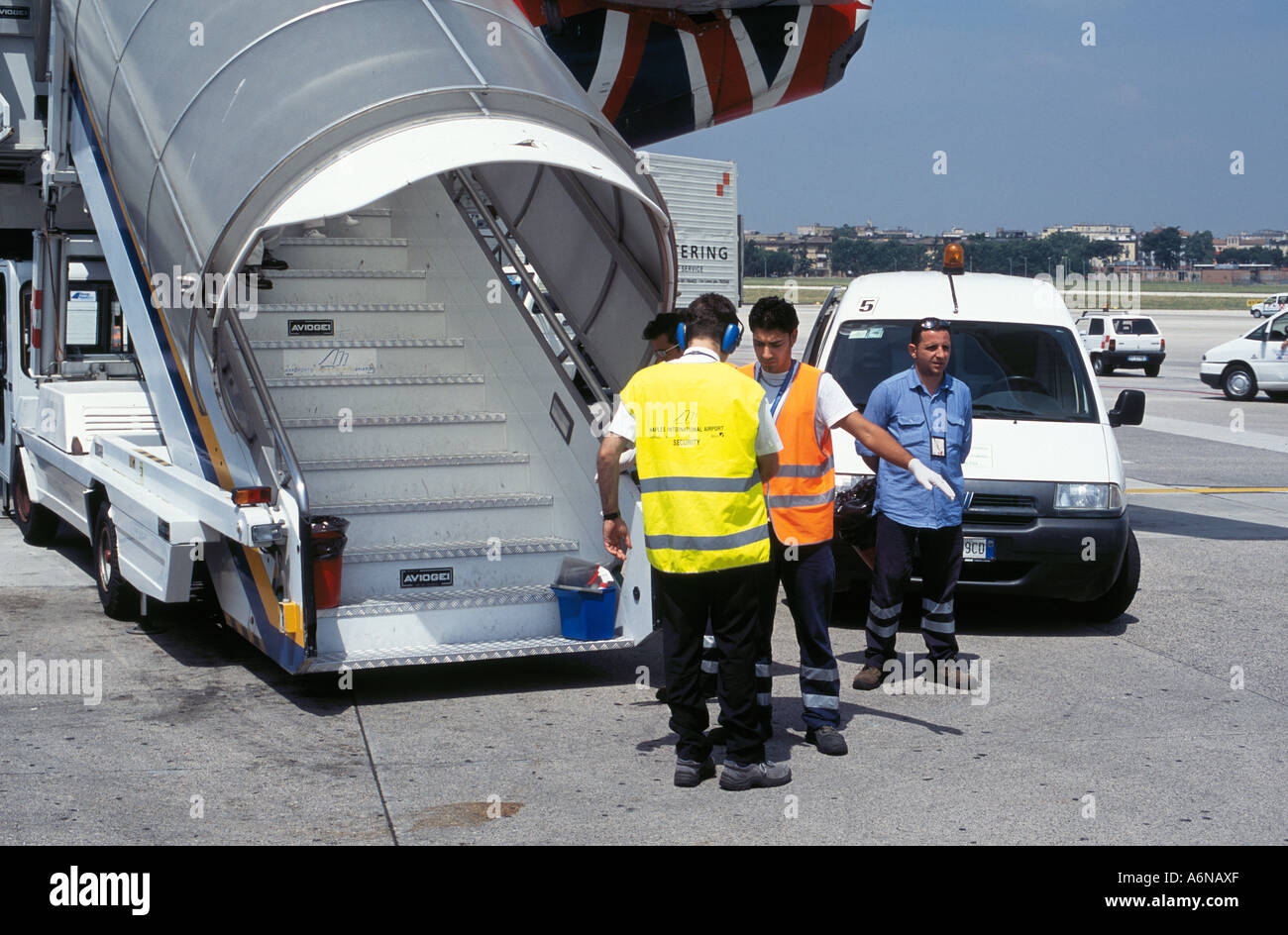 Security Guard checks a cleaner before he enters parked aircraft Naples ...