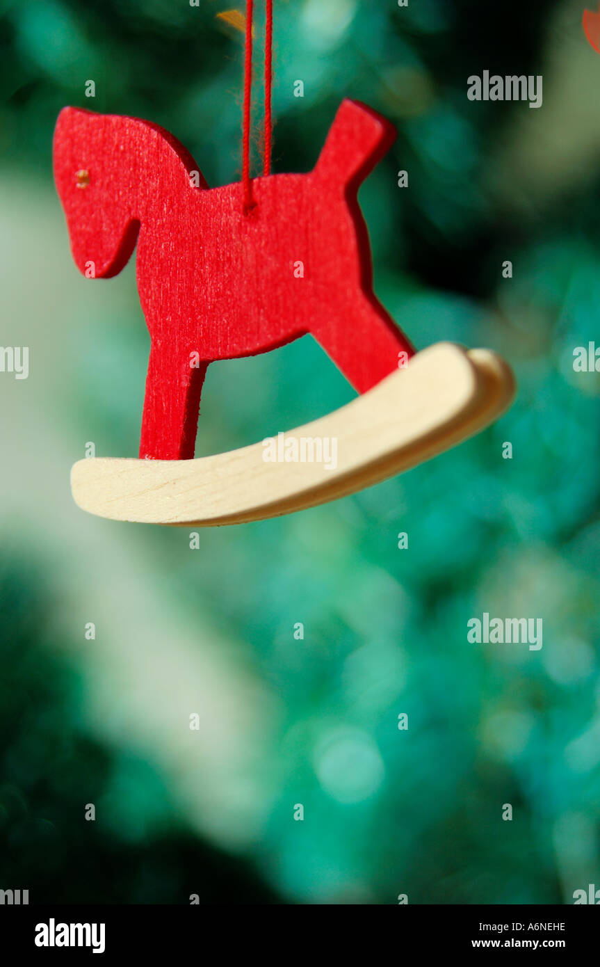 Small red hobby horse Christmas tree decoration green background ...