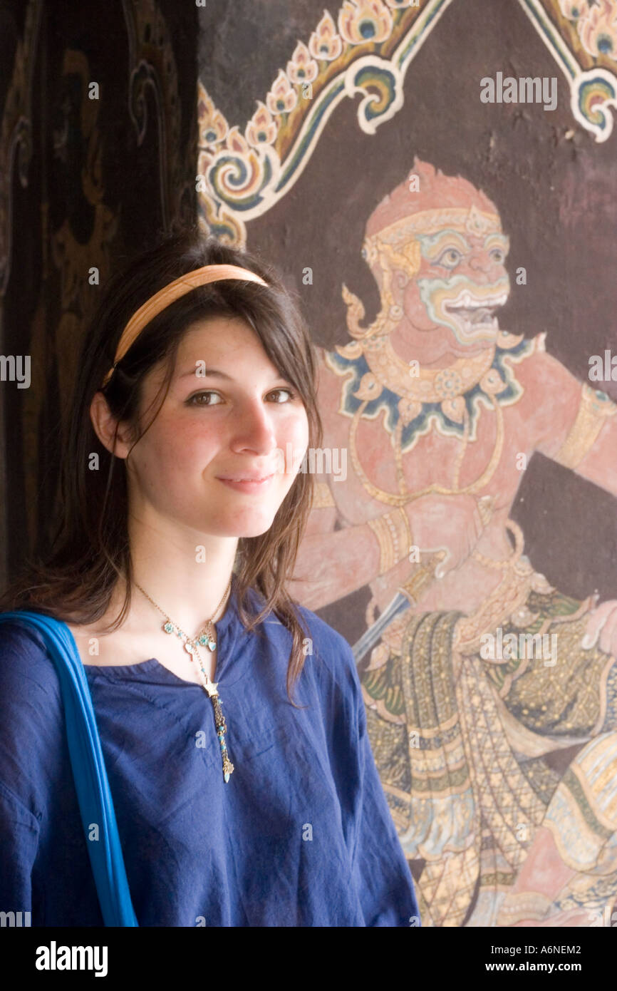 Female backpacker posing in front of a mural in The Grand Palace Stock ...