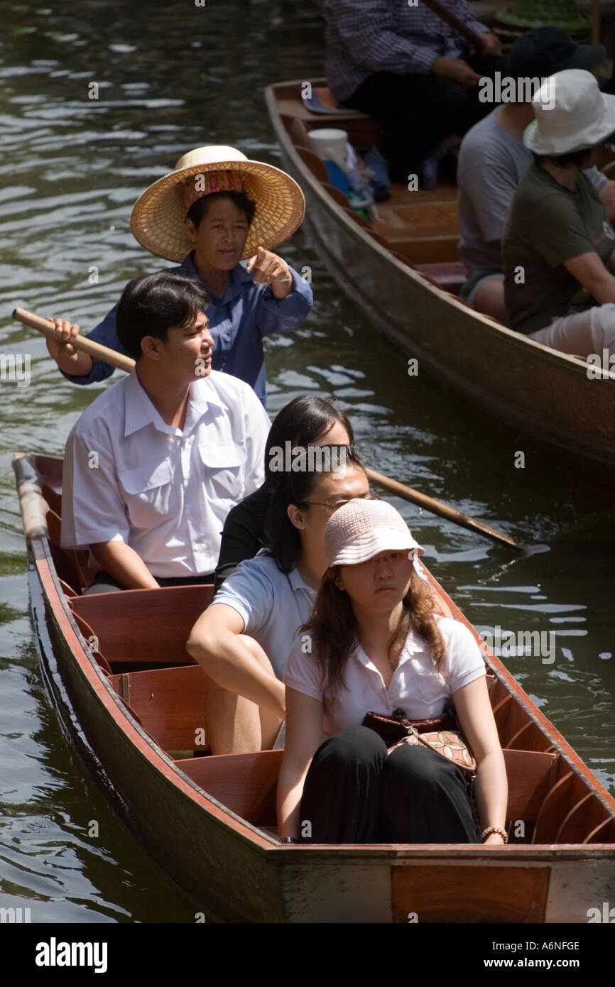 Thai boat lady rowing Asian tourists through a floating market Stock ...