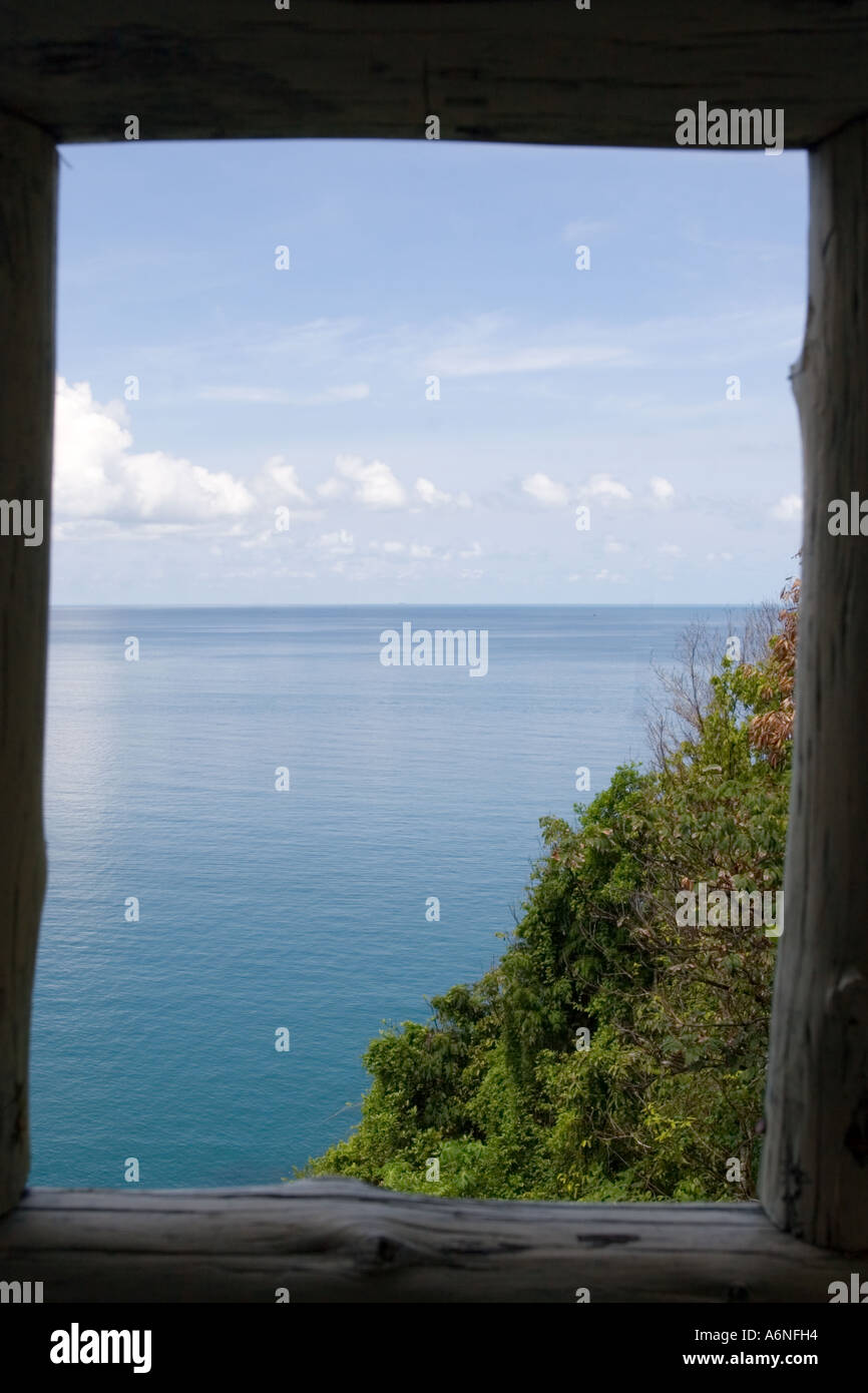 Tropical scenery pictured through a wooden a frame of wooden logs Stock ...